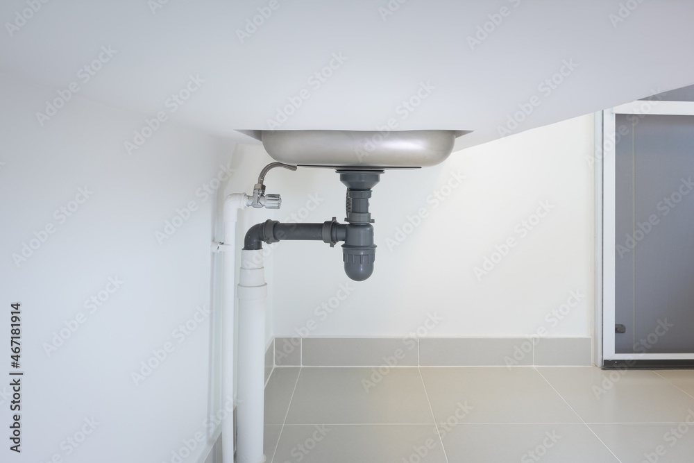 Drain pipe or sewer under kitchen sink. Pvc plastic pipe and flexible ...