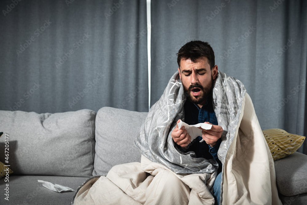 Sick man have common cold, flu and high fever. Ill young male struggle ...