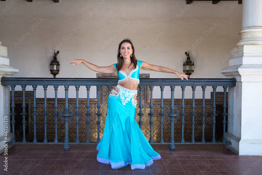beautiful young belly dancer is posing for the camera in a photo shoot ...