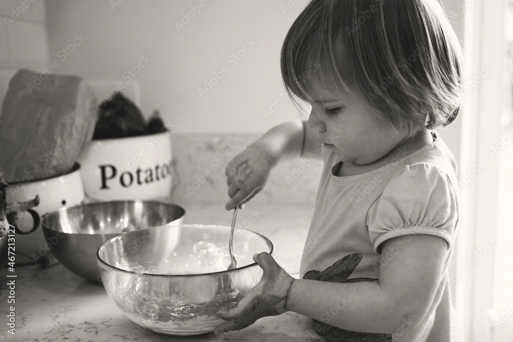 Grayscale photo of child mixing food in a bowl Stock Photo | Adobe Stock