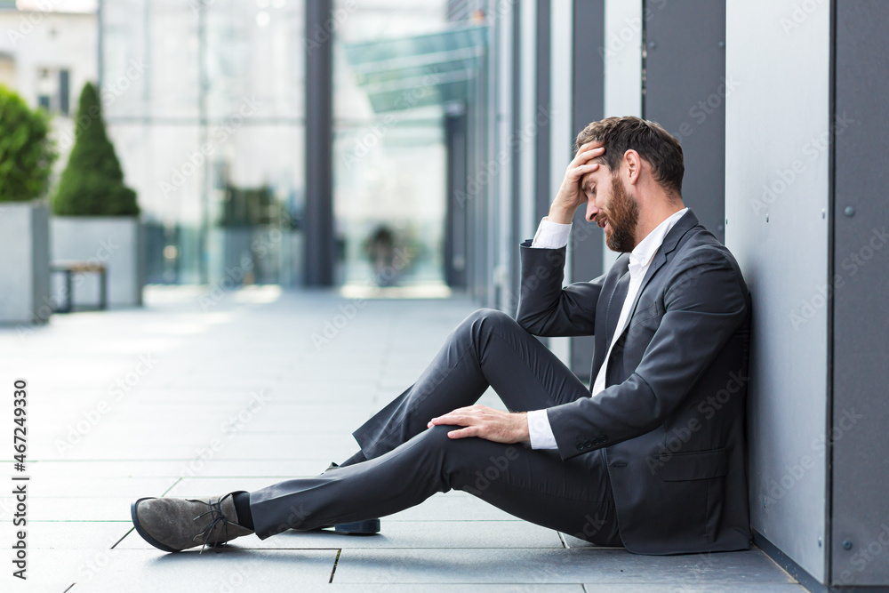 Sad depressed entrepreneur in formal suit worker man sitting near ...