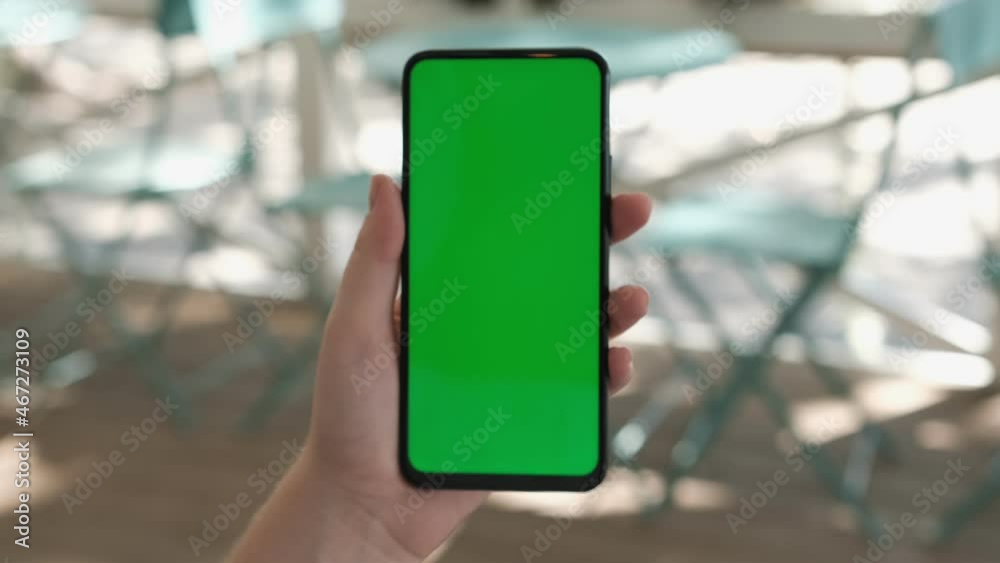 View of female hand holding and pressing on smartphone with mockup ...