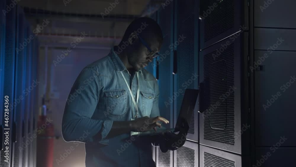 Young male engineer working on IT project with laptop in hands and ...