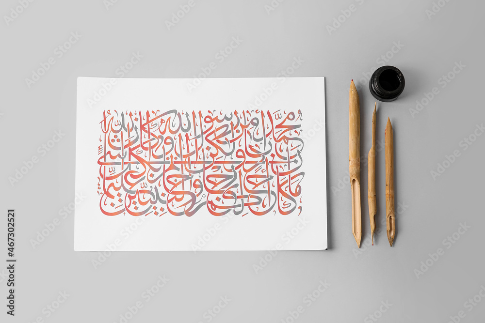 Poster Paper with Arabic text and tools for calligraphy on light ...