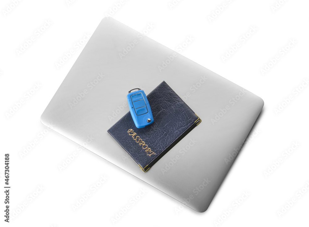 Laptop, passport and key fob on white background. Car rent concept ...