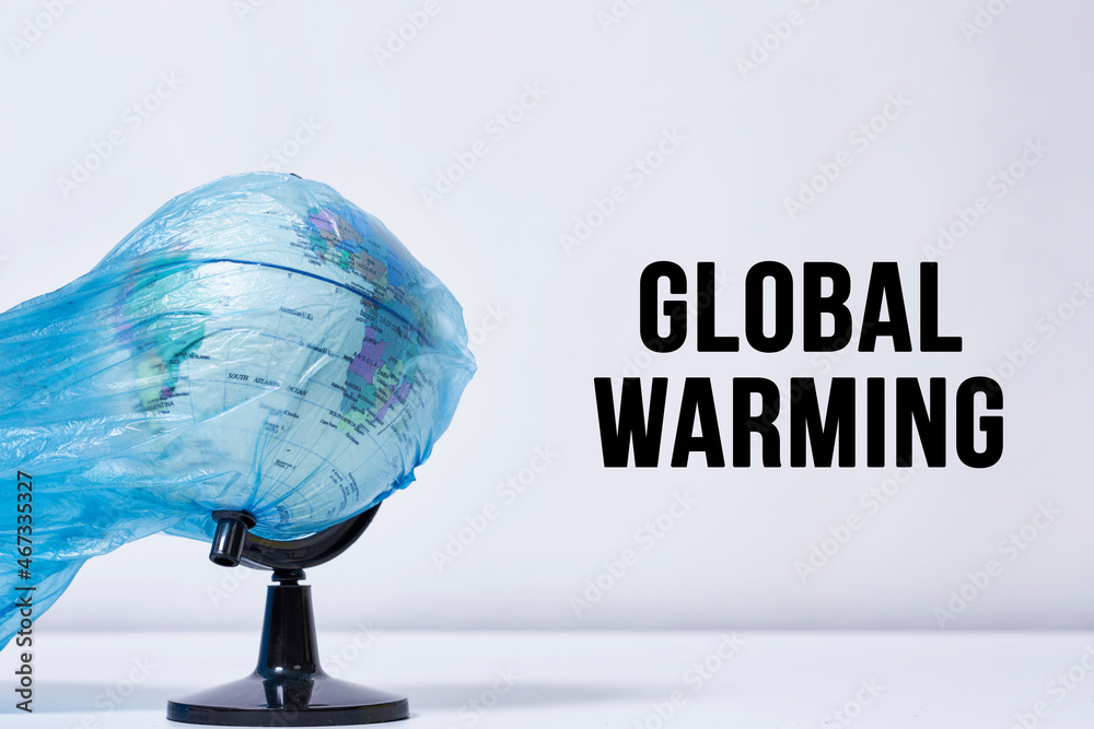 Global warming - the globe in plastic bag. A world globe wrapped in ...