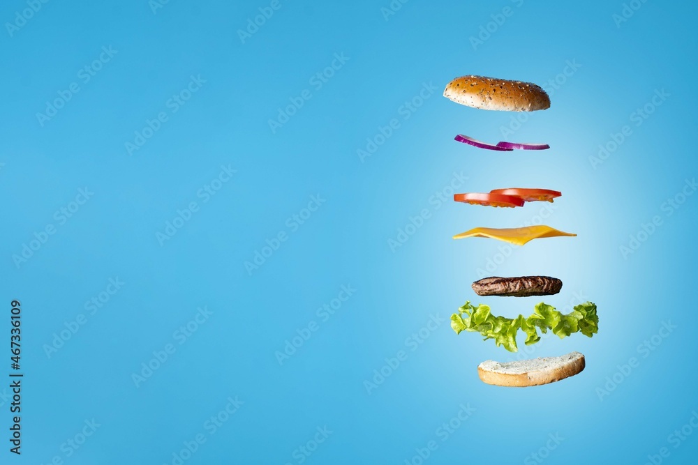 Beef burger split in mid air with space to write on the left of the ...