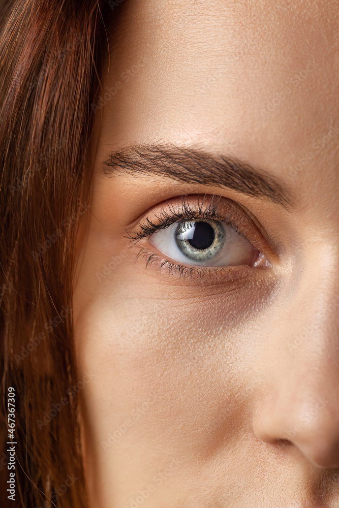 Cropped face of young beautiful girl without makeup isolated over gray ...