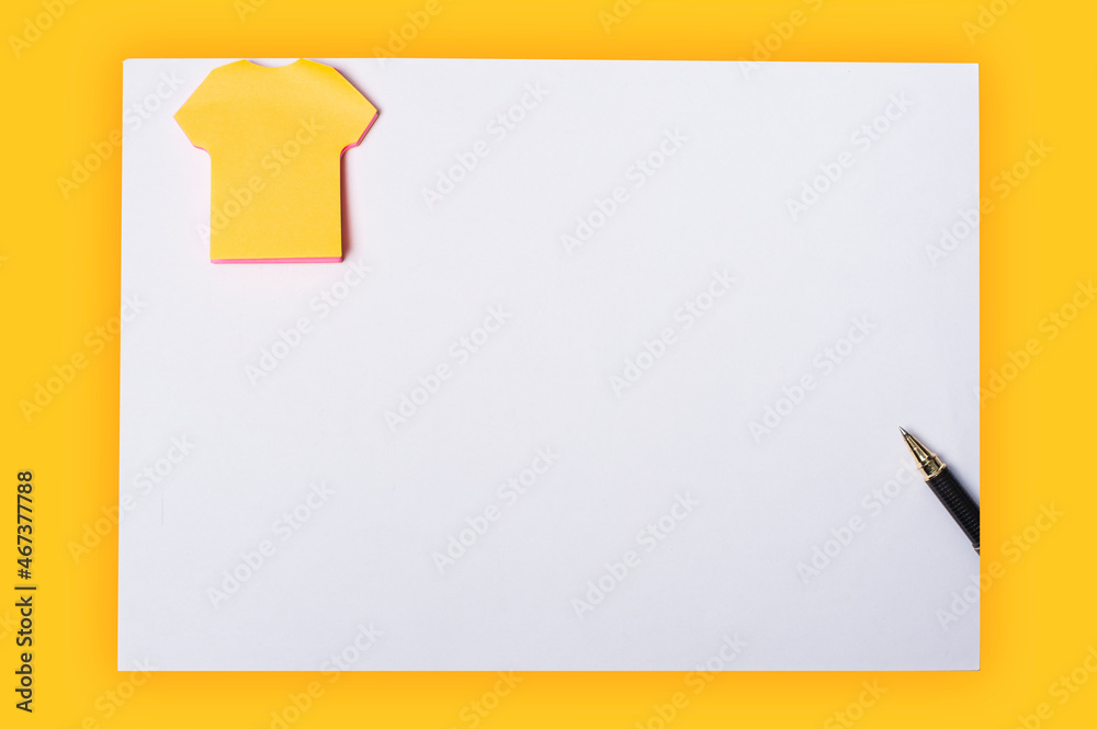 Yellow sticky notes, t shirt shaped, with black pen protruding from ...