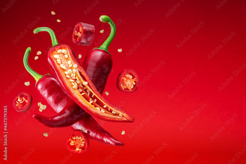 Fresh red chilli peppers and cross sections of chilli pepper with seeds ...