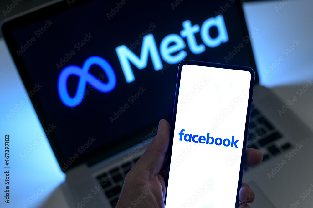 Laptop and smartphone with Meta and Facebook logo on display. New Mark ...