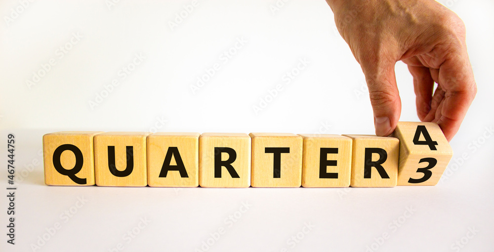 From 3rd to 4th quarter symbol. Businessman turns a cube and changes ...