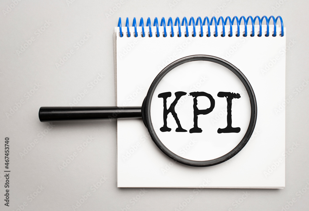 Magnifying glass with the word KPI on chart background Stock Photo ...