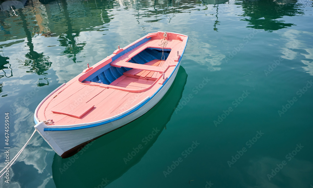 Cute pink wooden boat on the water at the dock Stock Photo | Adobe Stock