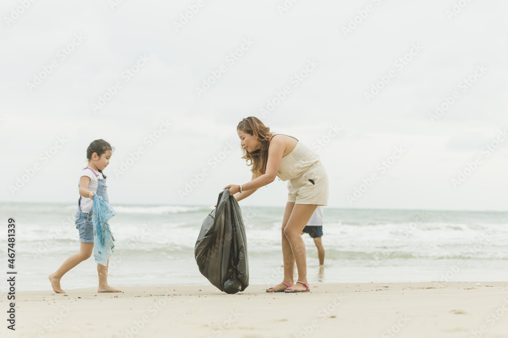 Asian family collecting plastic waste on the beach. young people ...