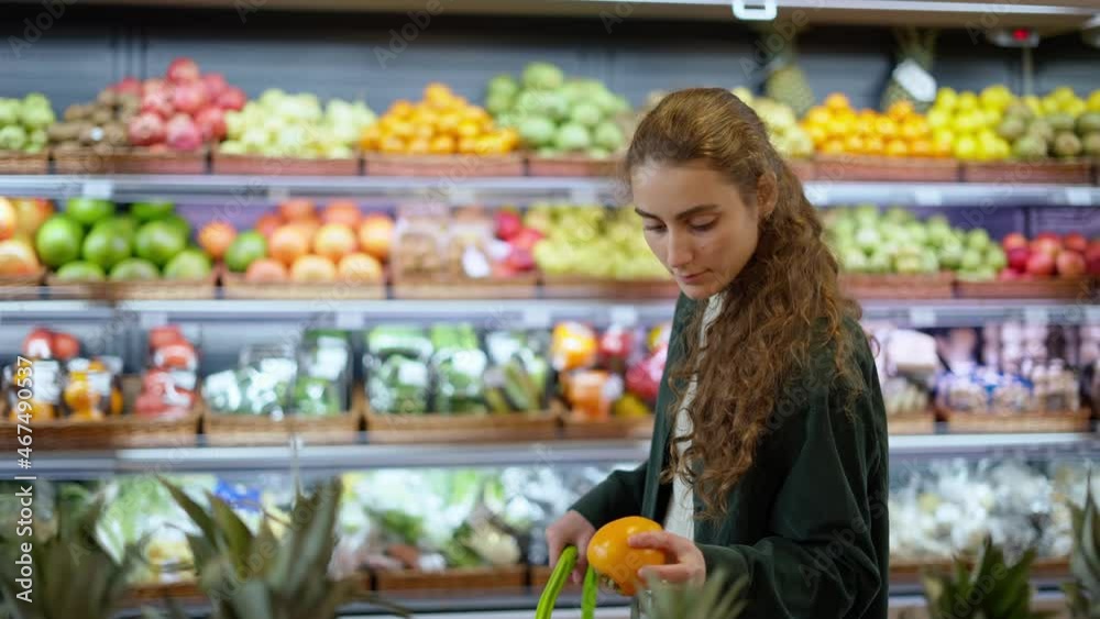 Female customer comparing different fruits at the food counter Stock ...