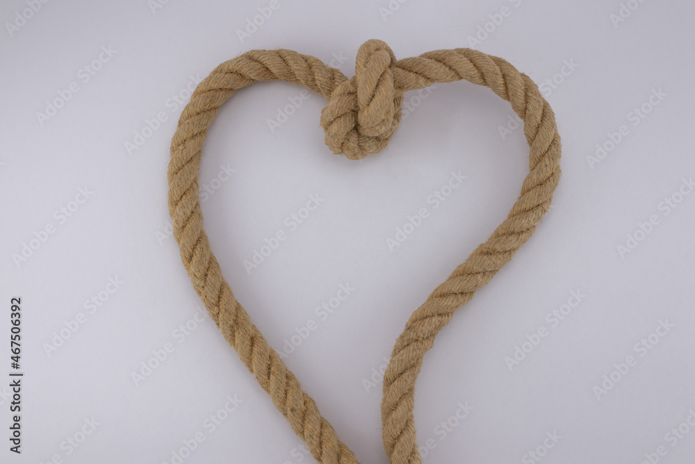 A rope with a knot tied in the shape of a heart Stock Photo | Adobe Stock