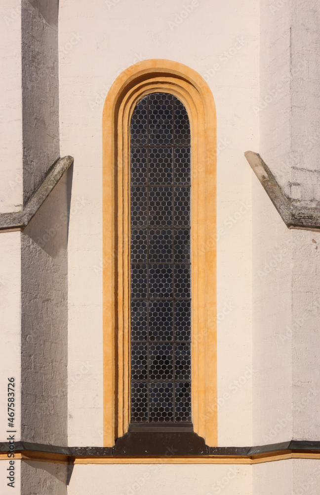 Romanesque round arch with painted frame and stained glass window on ...