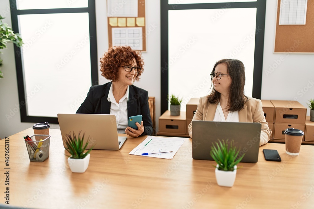 Group of two women working at the office. Mature woman and down ...