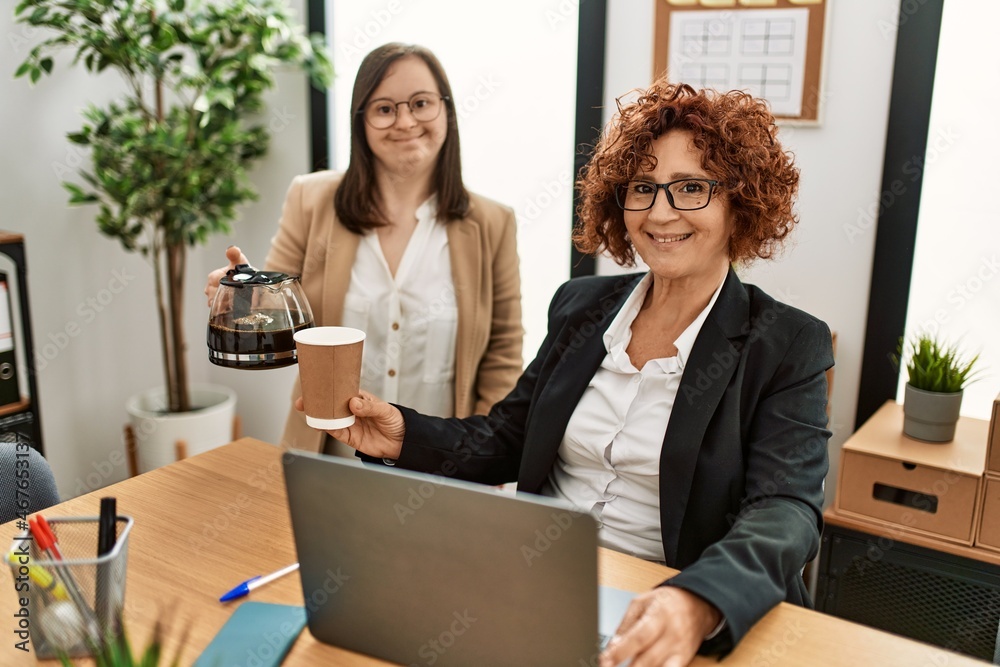 Group of two women working at the office. Mature woman and down ...