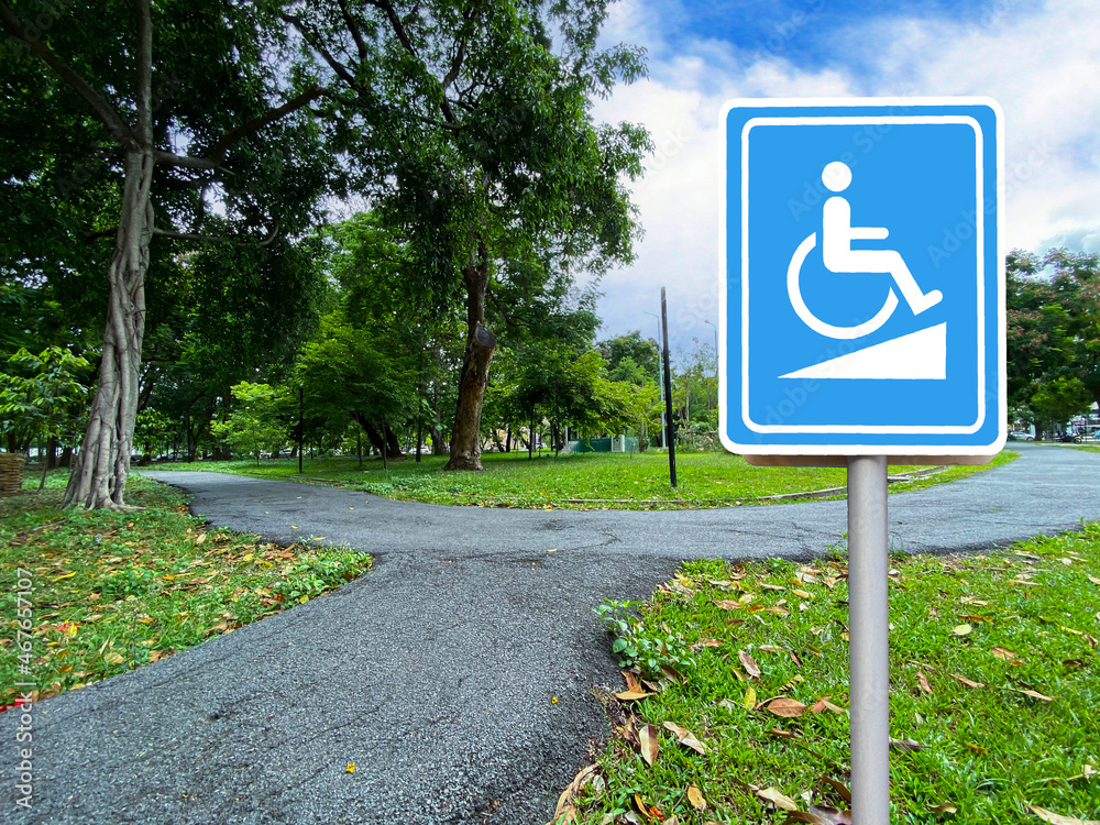 A warning sign of sloped pathway for disabled or elderly in public park ...