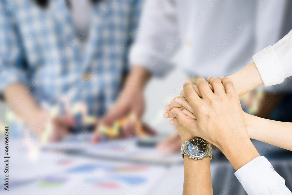 Hands clasped in collaboration top view of individuals bringing their ...