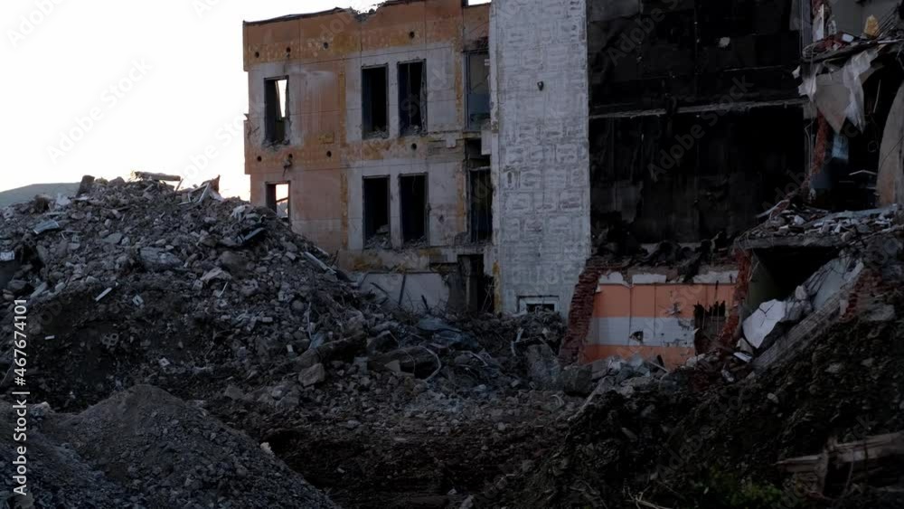 ruined house with empty windows, broken brick, cracks on the wall of a ...