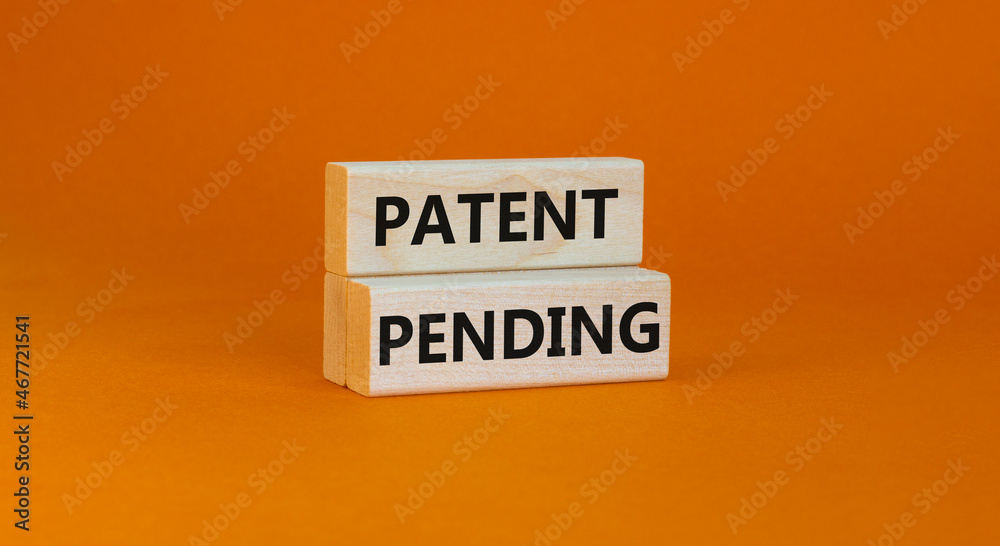Time to patent pending symbol. Concept words Patent pending on wooden ...