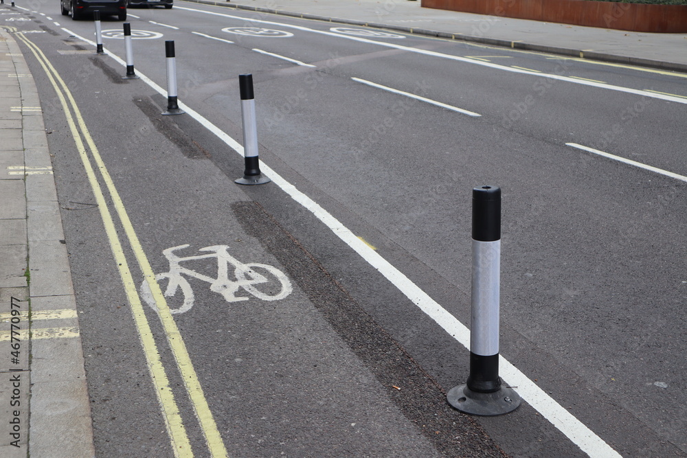 segregated cycle lane with bollards and double yellow road markings in ...