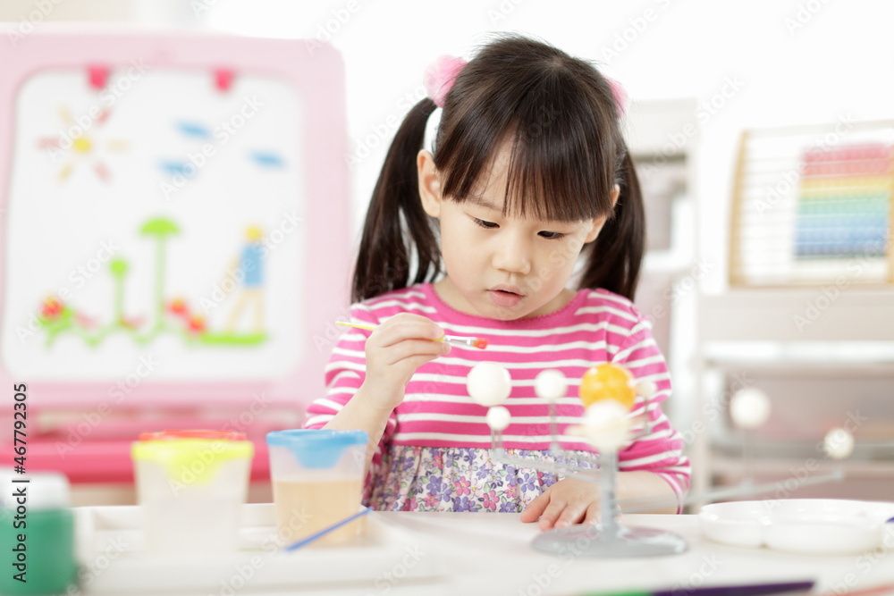 young girl making craft for homeschooling Stock Photo | Adobe Stock