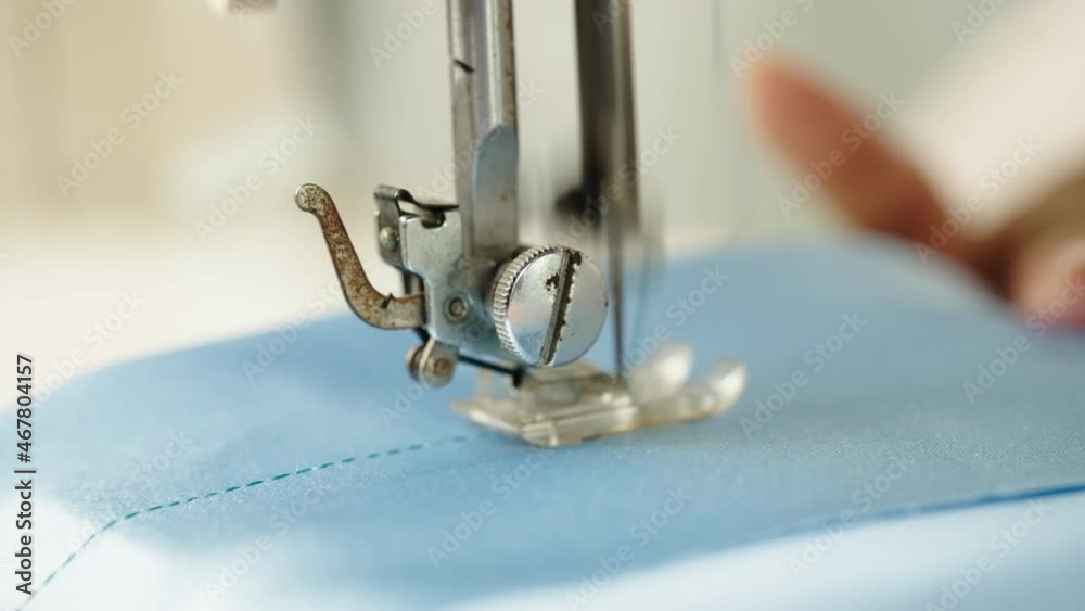 Close up of female hand working with sewing machine showing process of ...