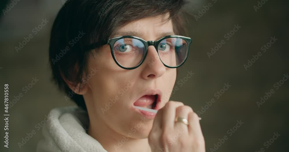 Woman swabbing cheek collecting samples for carrying out a Covid-19 ...