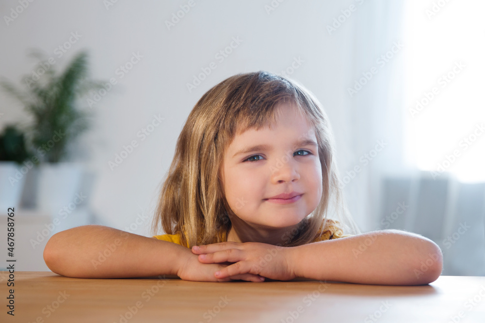Happy cute kid girl waving hands looking at camera and smiling talking ...