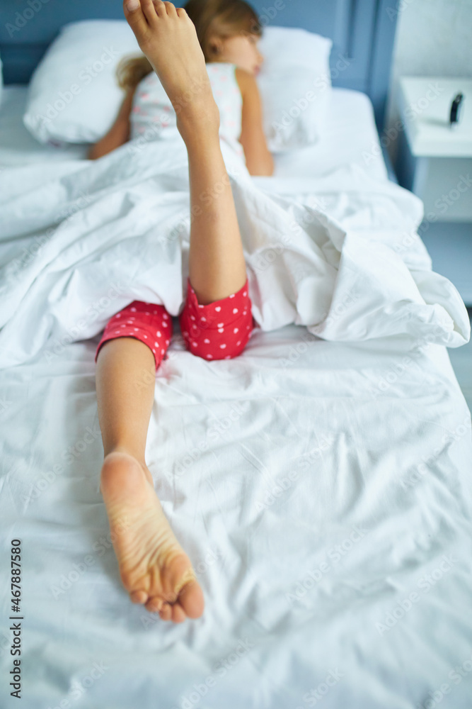 Girls Feet Covered With White Bed Sheet Sleeping In A Comfortable Bed