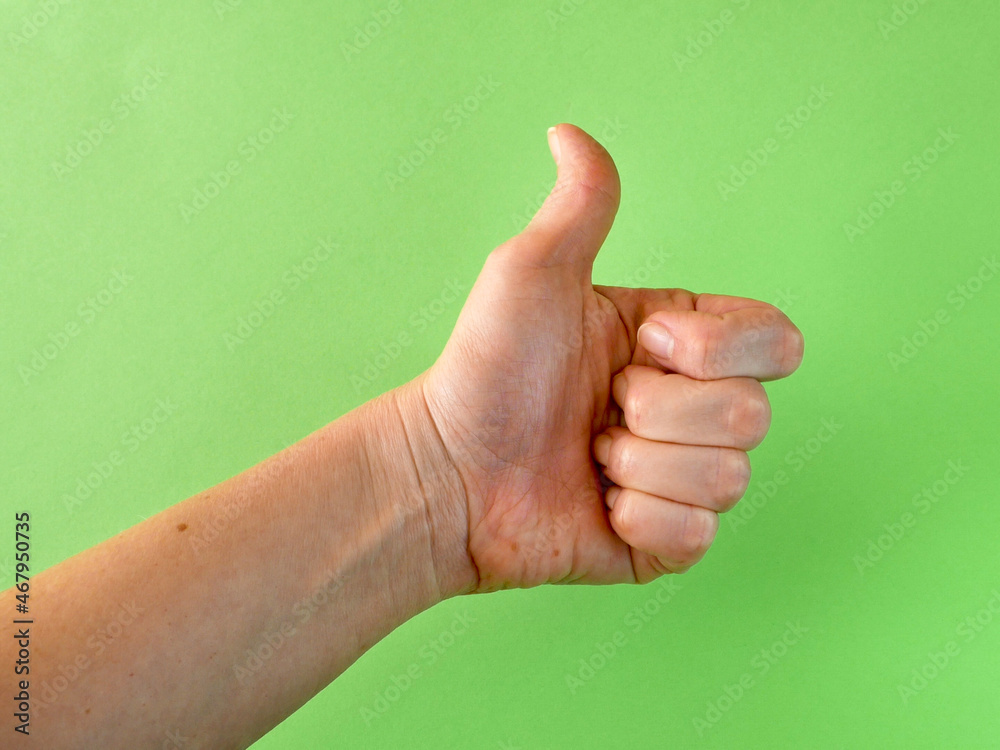 Thumbs up sign hand gesture on green screen. Simbol of approval like ...
