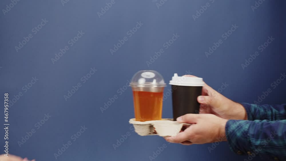 Food delivery service. Coffee to go in paper cup and juice in plastic ...