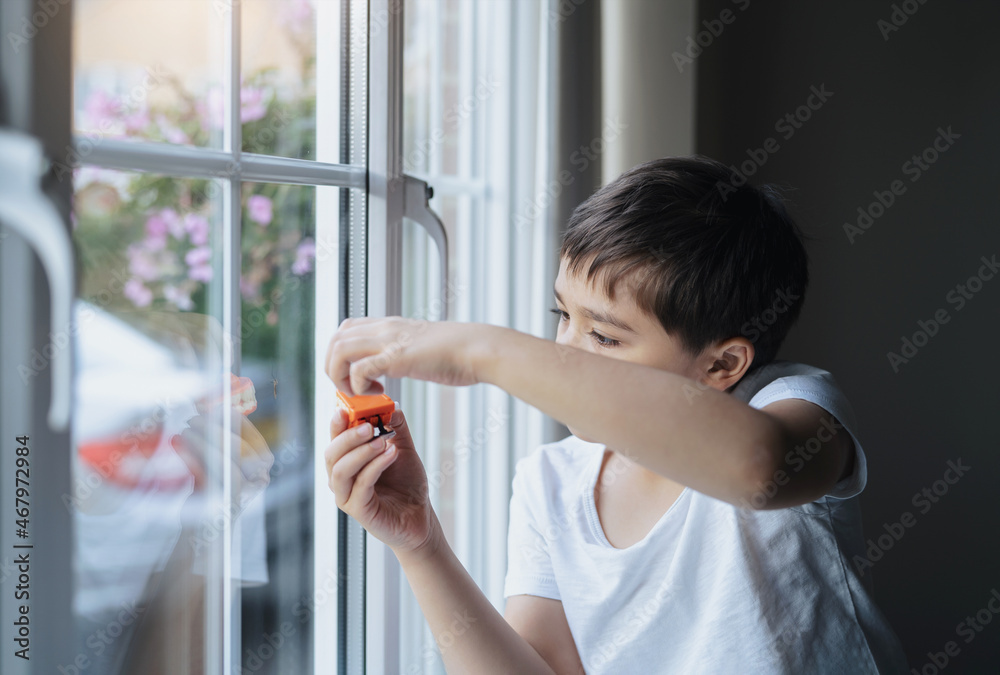 Kid playing with toy and looking at the midge climbing up outside of ...