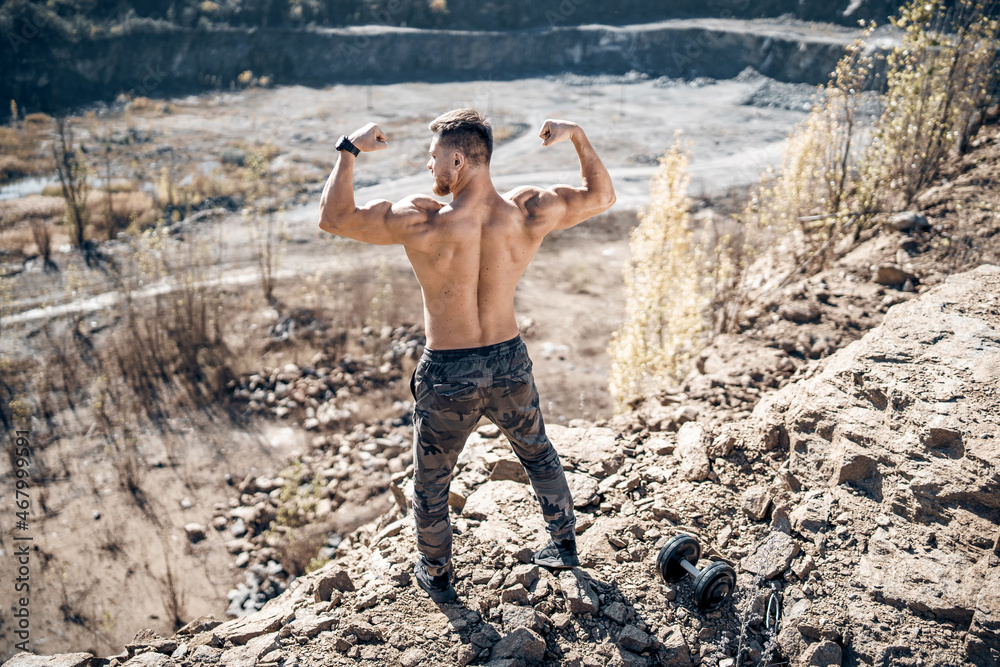 Strong handsome muscular man posing on nature landscapes. Sporty ...