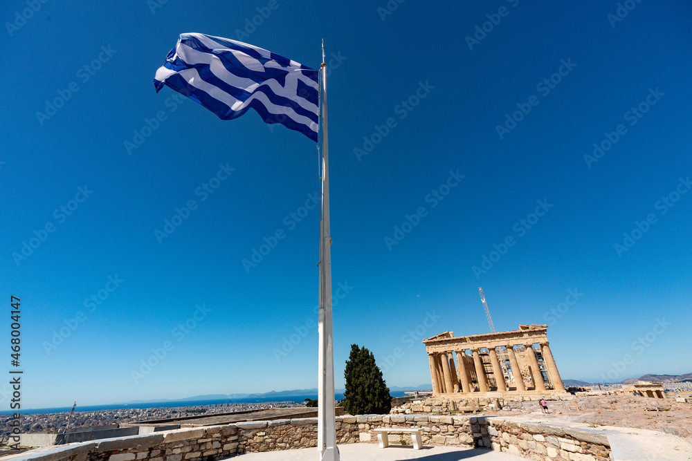 greek flag floating in front of the parthenon , on the acropolis of ...