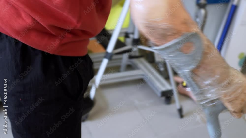 A man living with a disability with amputated legs and arms walks on ...