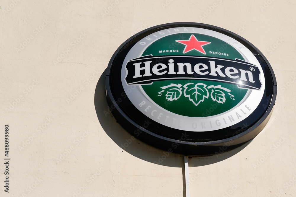 Heineken logo brand and text round sign of pale lager beer on facade ...