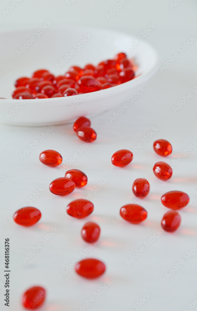 Soft gels of Gac oil or Momordica cochinchinensis oil on a spoon ...