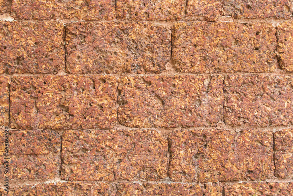 blur of red laterite brick wall Porous and fine-grained Background ...