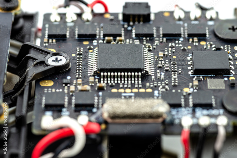 Macro pictures of an integrated circuit on a black PCB with a processor ...