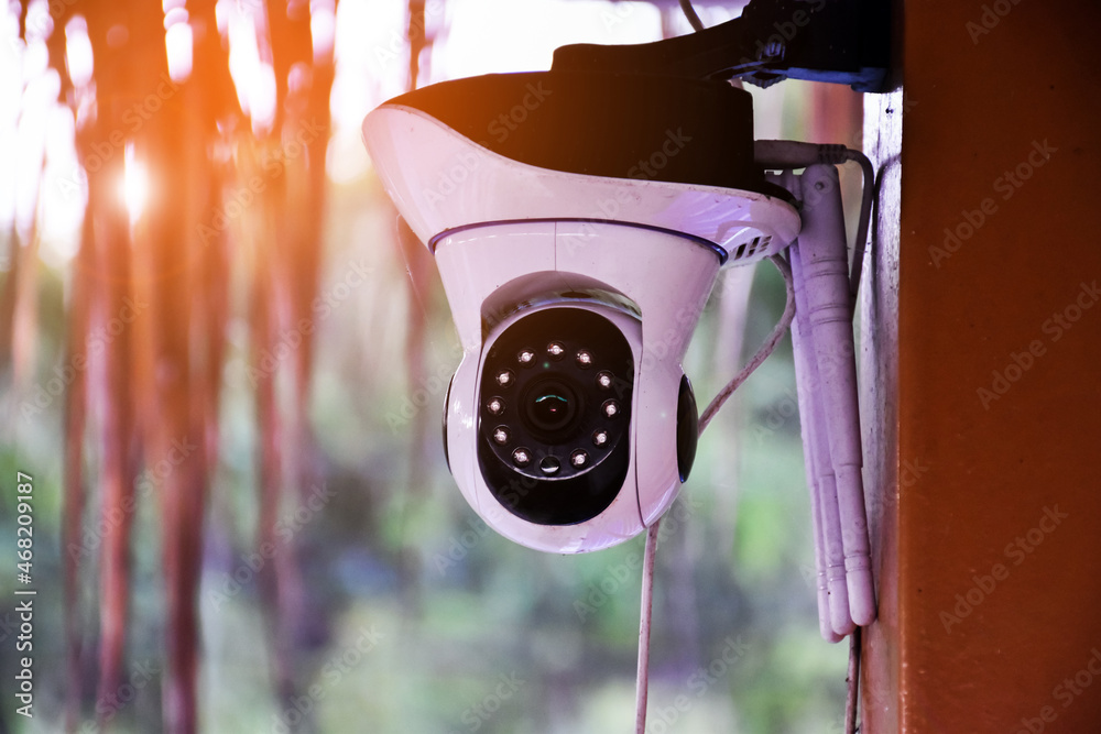 Wifi security camera or cctv camera installed on wooden wall of the ...