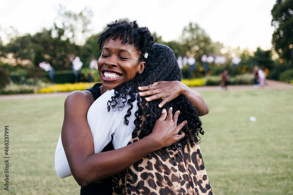 Black women sisterhood, smiling outdoors, embracing, hugging Stock ...