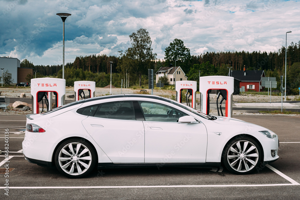 White Color Tesla Model S P85 Car Parked At Charging Station. The Tesla ...