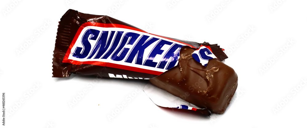 SNICKERS chocolate bar isolated on white background. Snickers is a ...