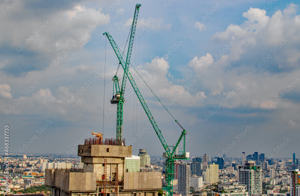 Construction crane or climbing crane on a roof of a high-rise project ...