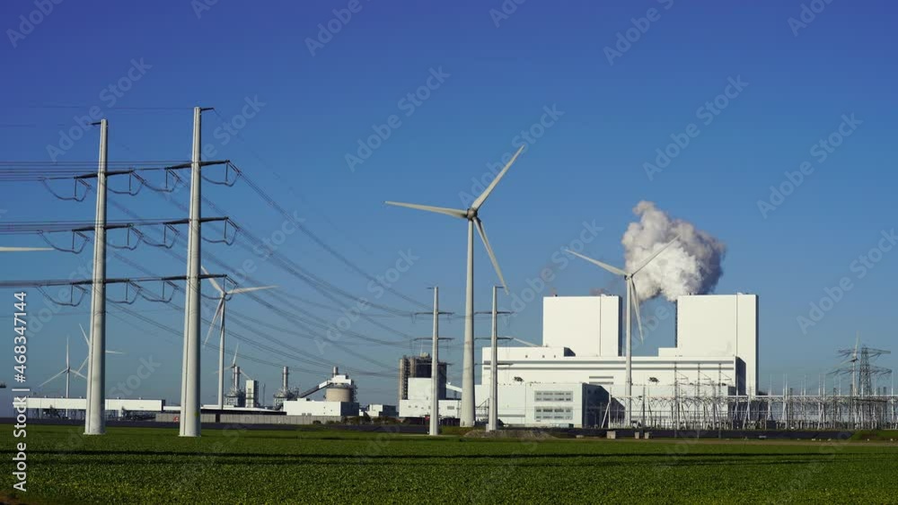 Fossil fuel (coal) power station, wind turbines and solar panels in the ...